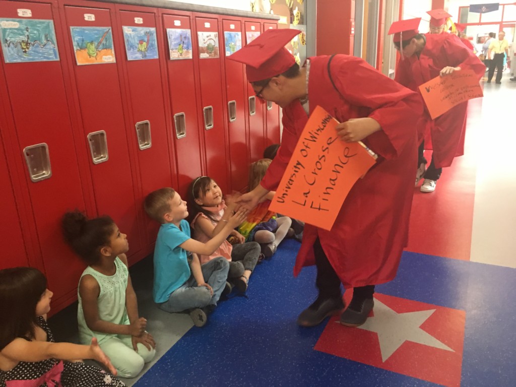 Graduates March to Cheering Elementary School Students! - La Crosse Promise